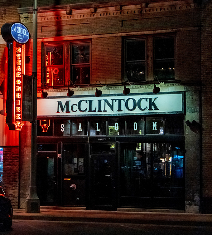Night falls on McClintock Saloon, where the brick facade glows with the warmth of Western hospitality.