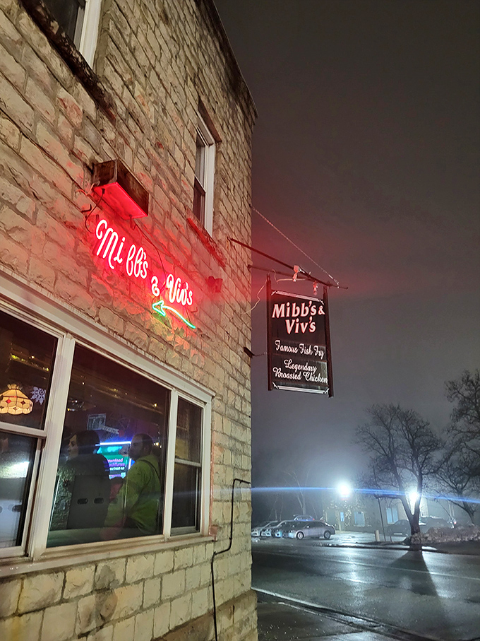 The glowing neon sign at dusk is like a lighthouse beacon, guiding hungry travelers to crispy chicken perfection inside.