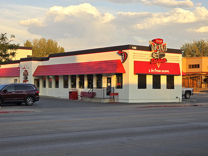 The desert sun sets, but Moab Diner's neon glow promises salvation for hungry travelers. Those red awnings have sheltered generations of satisfied diners.