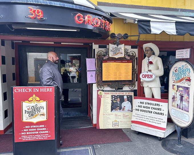 The entrance to Old Fisherman's Grotto &ndash; where the statue seems to say "Trust me, the chowder inside is legendary!"