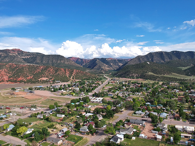 Aerial view of Parowan nestled among stunning red rock formations, showing how nature frames this peaceful community perfectly.