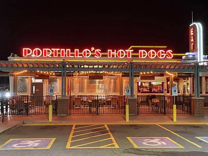 Portillo's neon sign glows like a hot dog lighthouse in the night. Those Chicago-style dogs inside are worth navigating toward.