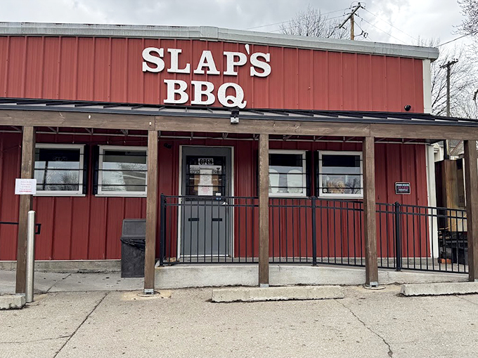 The entrance to Slap's BBQ beckons with rustic charm. This no-nonsense facade hides a world of smoky treasures within.