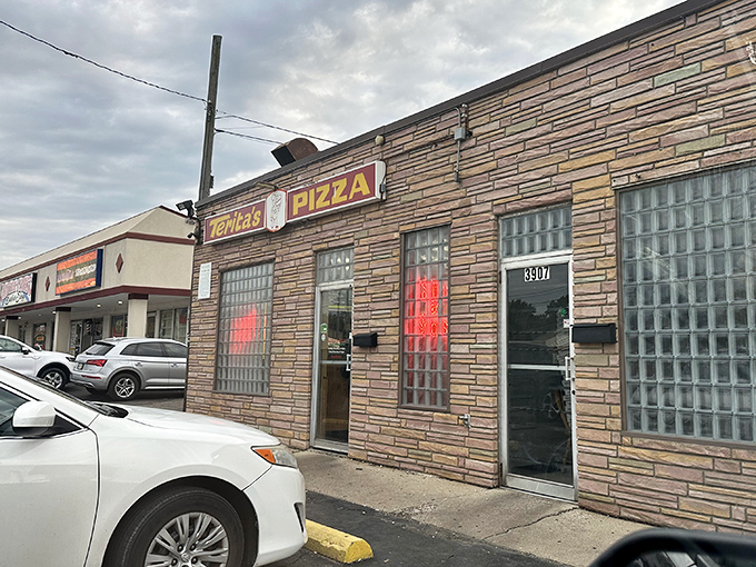 Glass block windows and weathered brick tell stories of countless satisfied pizza lovers.