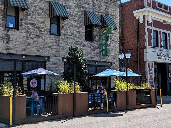 Blue umbrellas create the perfect outdoor breakfast spot where Kansas sunshine meets perfectly prepared morning meals.
