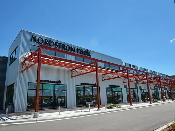 Modern industrial chic meets discount heaven at The Mayfair Collection, where Torrid's bold signage promises fashion for all.