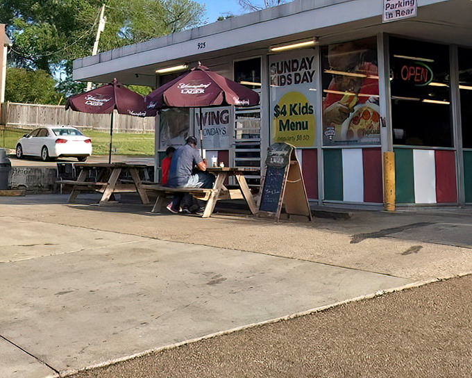 Italian flag colors stripe this modest storefront, signaling authentic flavors hiding in plain sight nearby.
