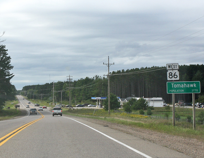 Tomahawk welcomes road-weary travelers with a classic green highway sign and the promise of northwoods peace.