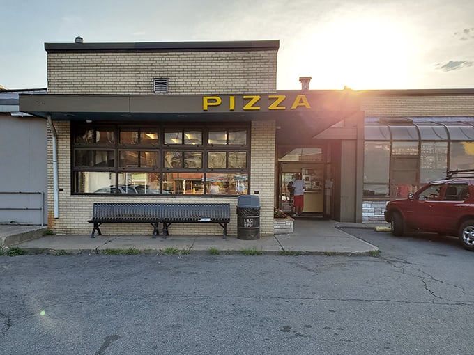 Behind that simple storefront, Lawrence's best-kept pizza secret transforms dough into pure golden happiness daily.