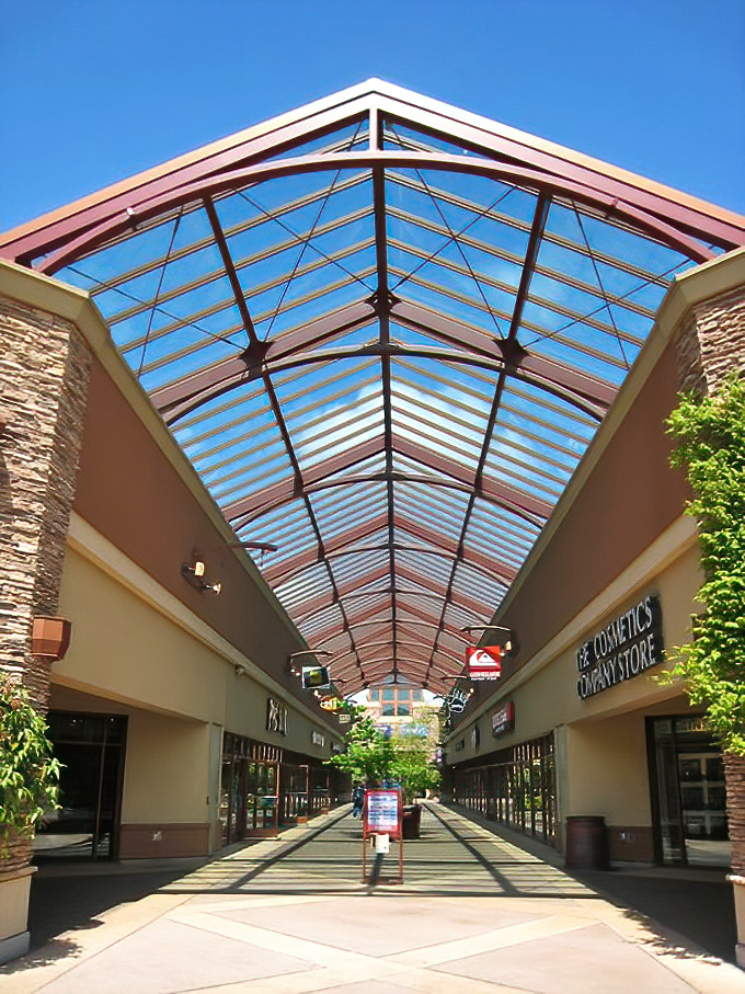 Sunlight streams through the soaring glass ceiling, creating a cathedral-like shopping experience. Retail therapy with a side of vitamin D.