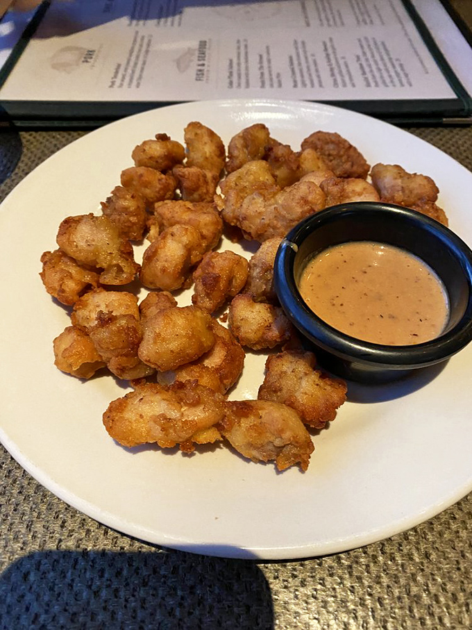 Golden-fried nuggets of alligator with creamy dipping sauce &ndash; proof that sometimes the predator becomes the most delicious prey.