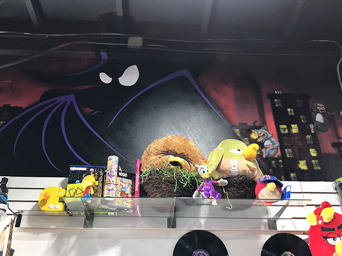 Even villains deserve shelf space! This eclectic display showcases everything from Angry Birds to classic cartoon characters against a dramatic backdrop.