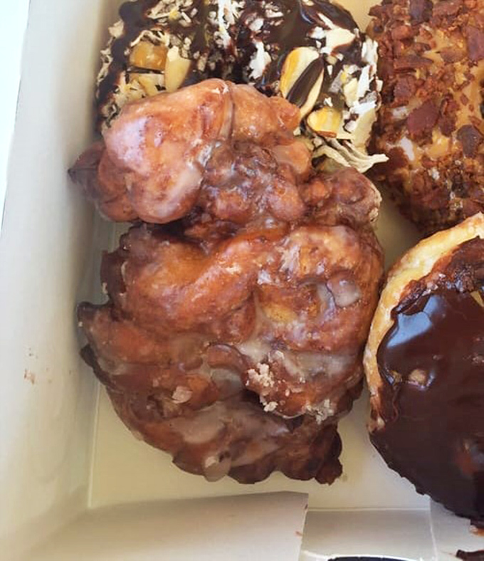 This box of joy features an apple fritter that doesn't just have apple—it's practically hosting an apple convention with cinnamon as the keynote speaker.