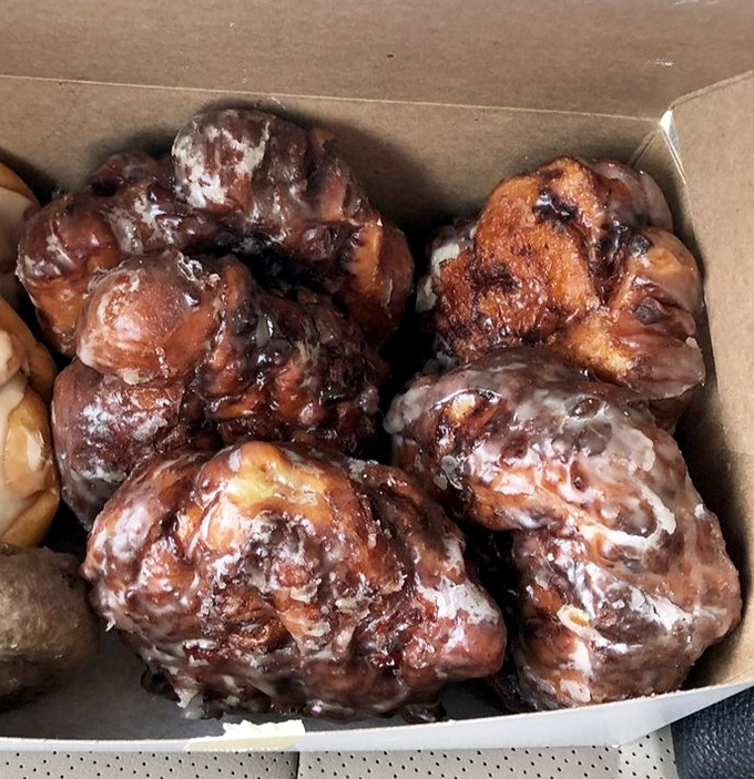 These apple fritters aren't just pastries; they're architectural marvels of caramelized glory. Each craggy peak and valley holds promises of apple-cinnamon bliss.