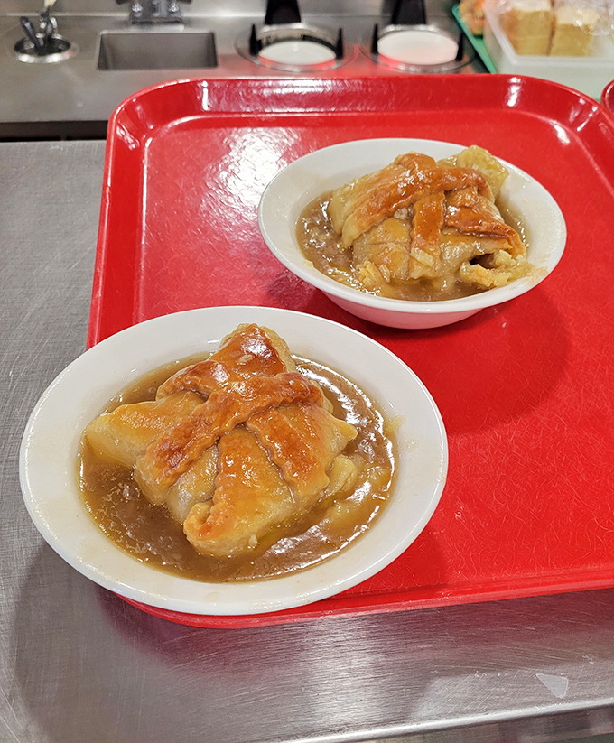 These apple dumplings arrive swimming in cinnamon sauce like edible life preservers in a sea of deliciousness.