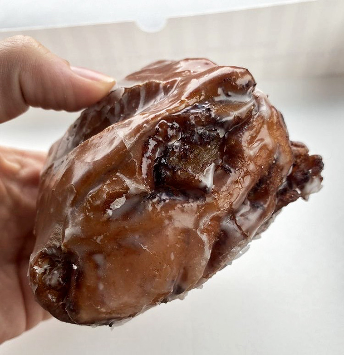 Behold the mythical apple fritter – a cinnamon-spiced flavor bomb with crispy edges and tender interior that makes grown adults contemplate stealing from each other's plates.