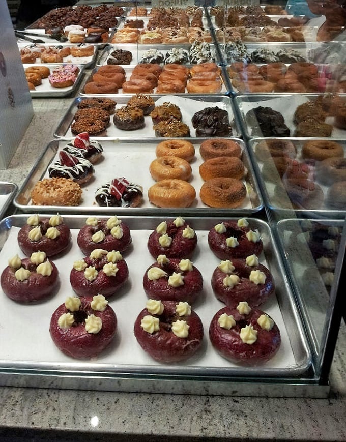 Behold the display case of dreams, where every tray holds a different path to pure sugary bliss.