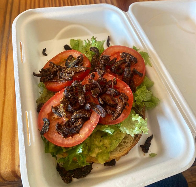 Avocado toast that could make a mortgage broker weep with joy. That tempeh "bacon" on top is the crown jewel of this open-faced masterpiece.