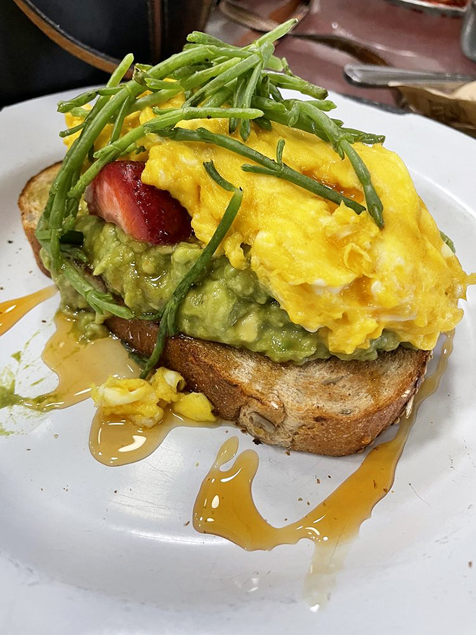 Behold the avocado toast that launched a thousand road trips, complete with strawberries, eggs, and that magical hot honey drizzle.