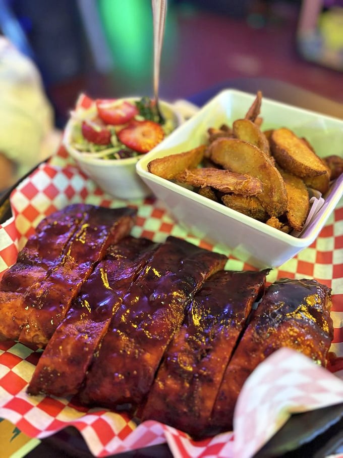 Glistening baby back ribs with that perfect bark, served alongside golden potato wedges. This isn't just dinner&mdash;it's edible artwork with a smoky soul.