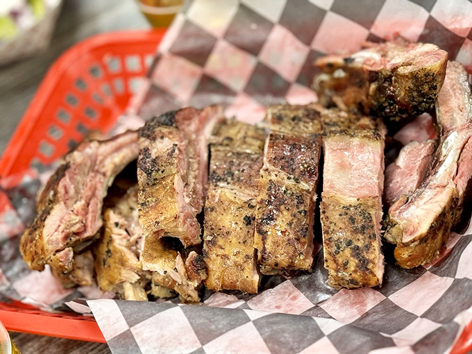 These ribs achieve that perfect bark that makes pitmasters weep and customers return like clockwork.