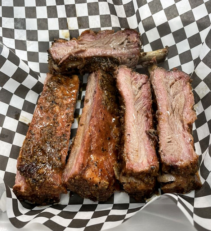 Behold, meat candy in its natural habitat. These ribs showcase that perfect bark and pink smoke ring that makes barbecue enthusiasts weak in the knees.