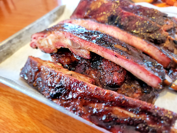 Behold the star attraction: ribs with that perfect pink smoke ring that makes barbecue enthusiasts weak in the knees.