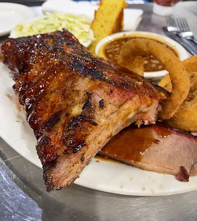 These ribs don't just fall off the bone – they practically leap into your mouth, glistening with that perfect lacquer of sauce and smoke.