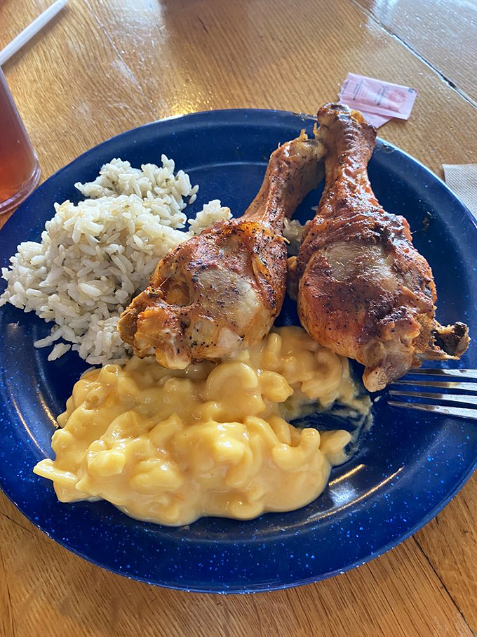 Golden fried chicken legs perch atop creamy mac and cheese and rice&mdash;a holy trinity of Southern comfort that makes diets weep and taste buds rejoice.
