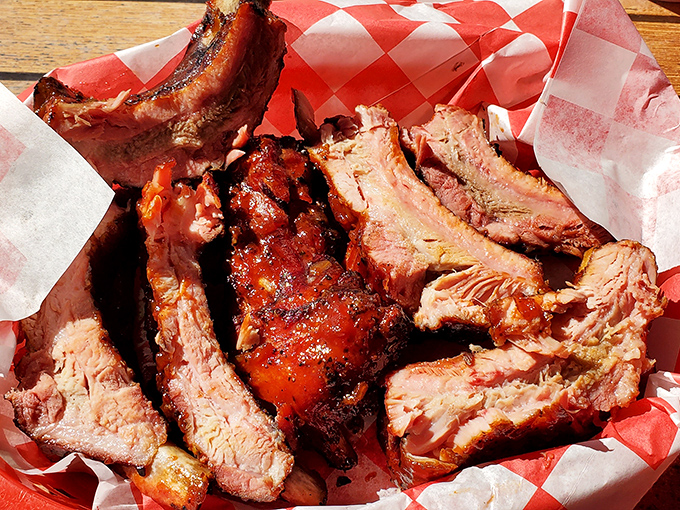 Behold the star of the show: ribs with that perfect mahogany bark and pink smoke ring that would make even vegetarians question their life choices.