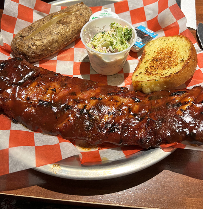 Behold, the star of the show: ribs lacquered in that glistening sauce that probably deserves its own ZIP code. Resistance is futile, napkins are mandatory.