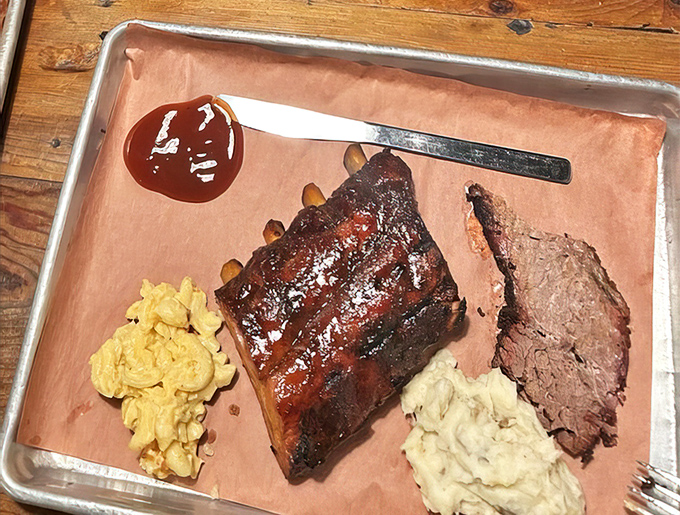 Behold the holy trinity of BBQ perfection: fall-off-the-bone ribs, creamy mac and cheese, and brisket so tender it practically surrenders at the sight of your fork.