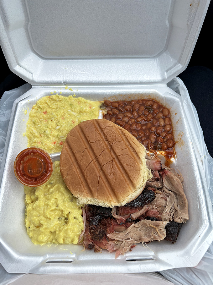This isn't just a sandwich; it's a masterclass in smoke and patience&mdash;pulled pork, potato salad, and beans in perfect harmony.