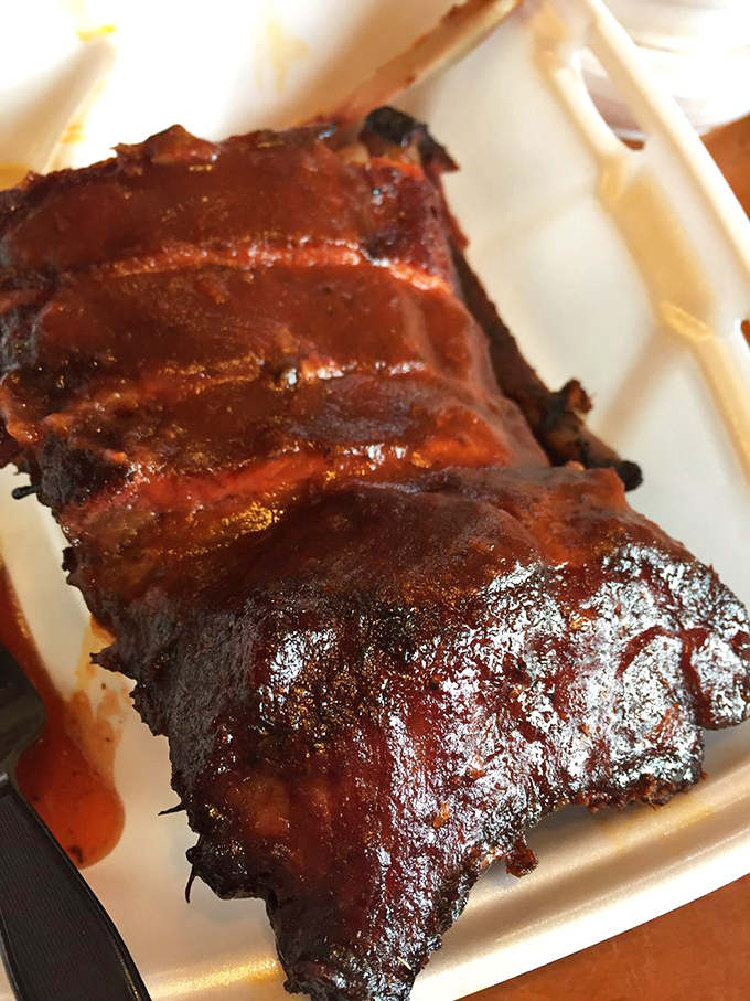 These ribs don't just fall off the bone &ndash; they practically leap onto your fork, glistening with that perfect lacquer of sauce and smoke.