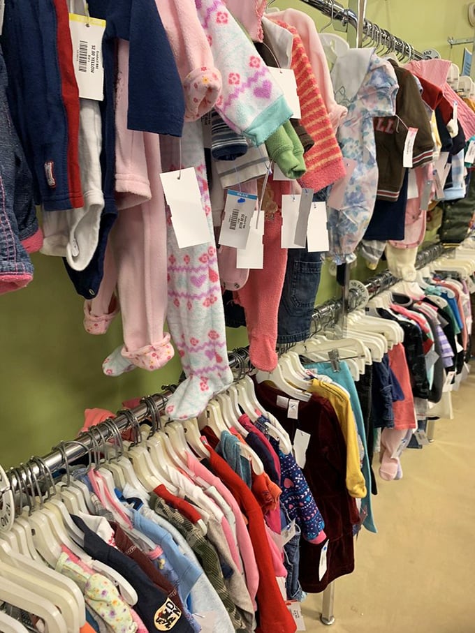 Baby clothes galore! Tiny outfits with plenty of life left in them hang expectantly, ready for the next generation of crawlers and toddlers.