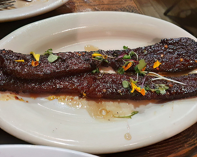 This isn't bacon; it's a thick-cut, caramelized pork revelation that makes regular bacon look like it's not even trying.