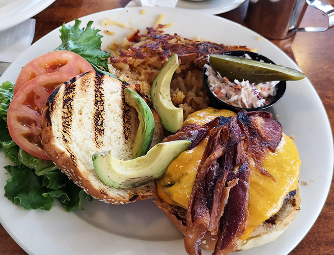 This isn't just a burger&mdash;it's architecture. Layers of bacon, cheese, and avocado create a savory skyscraper that demands both hands and napkins.
