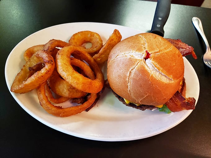 This burger isn't just wearing bacon like an accessory&mdash;it's a full commitment. Those onion rings could double as delicious golden bracelets.