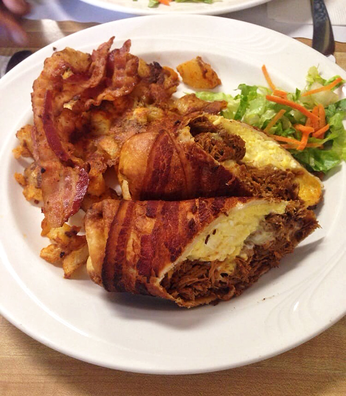 Bacon-wrapped pulled duck nestled against crispy home fries &ndash; when breakfast decides to dress up for the occasion.