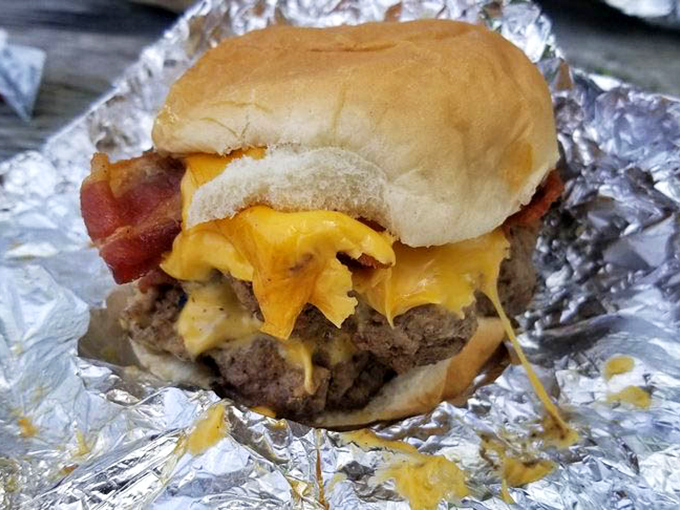 This isn't just a bacon cheeseburger; it's edible architecture. The melted cheese cascades like a yellow waterfall of happiness.