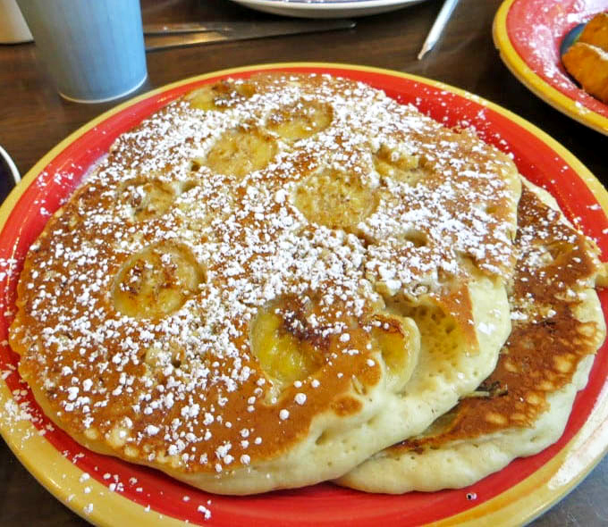 These banana pancakes aren't just breakfast&mdash;they're edible sunshine dusted with powdered sugar. The crispy edges are nature's way of saying "good morning."