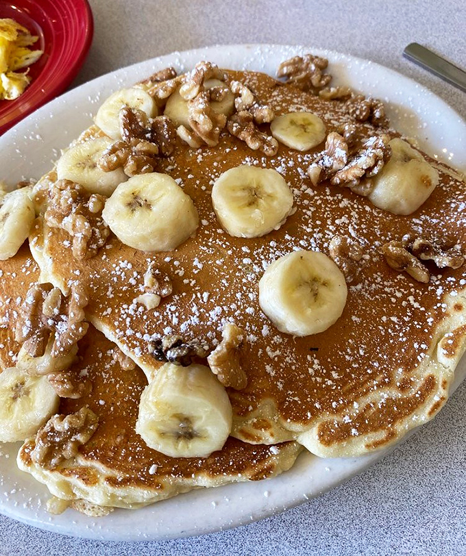 Banana walnut pancakes that don't just satisfy hunger&mdash;they solve existential crises. The powdered sugar snowfall is just showing off.