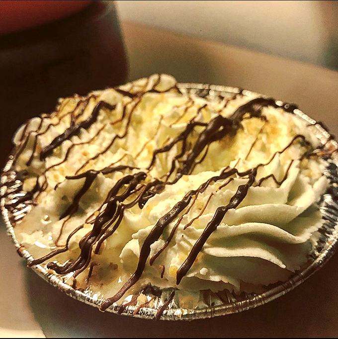 Banoffee pie with chocolate drizzle&mdash;proof that banana, toffee, and cream can achieve what most international peace treaties cannot.