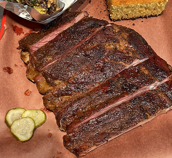 These ribs don't just fall off the bone &ndash; they practically leap into your mouth, their smoke ring telling tales of patient, masterful cooking.