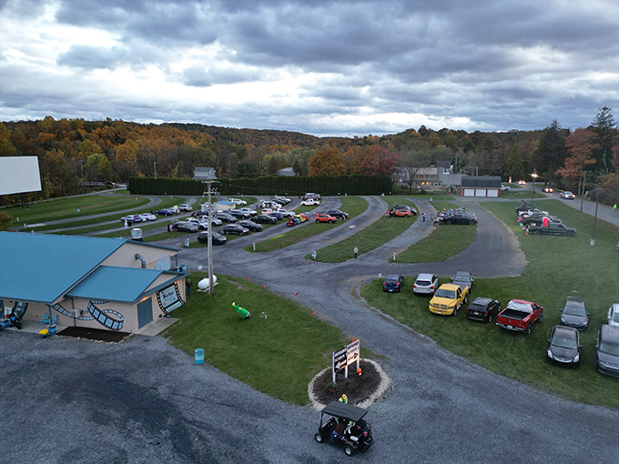 Concentric rings of automotive devotion, arranged like a drive-in colosseum. From above, you can almost hear the collective gasps and laughter.