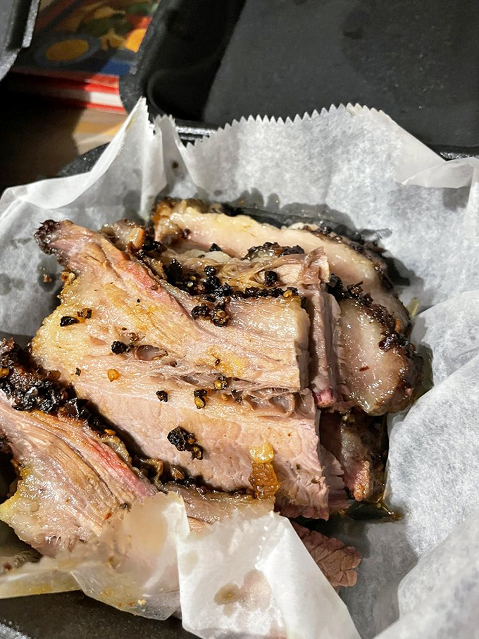 Brisket so tender it practically surrenders at the sight of your fork. That pink smoke ring isn't just pretty – it's the barbecue equivalent of a Michelin star.