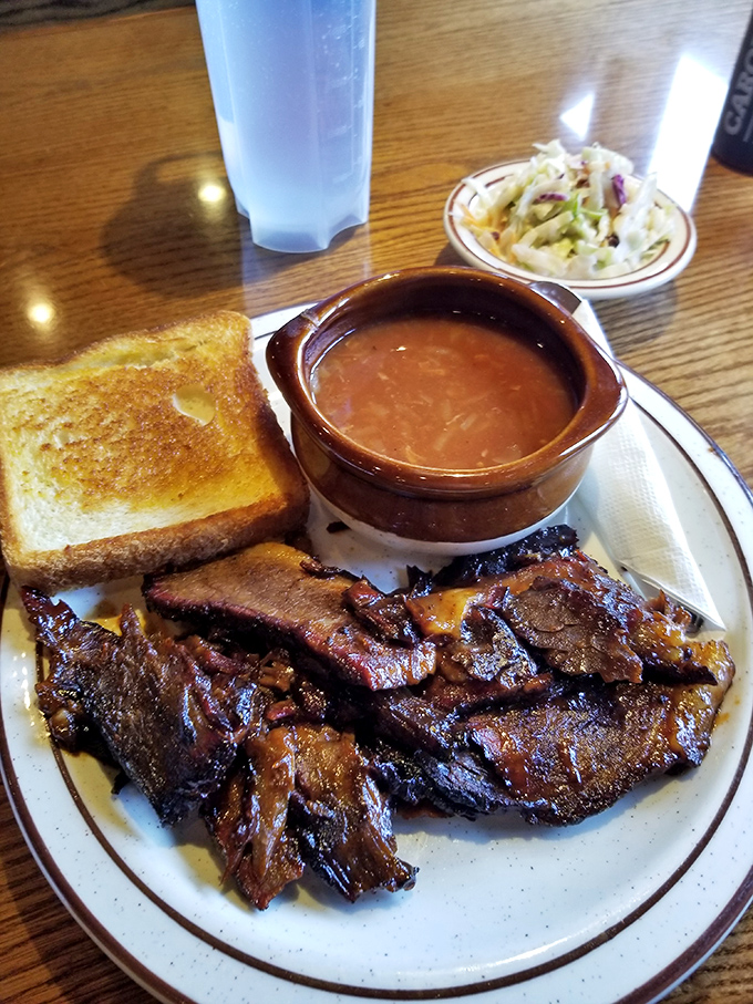 Behold the brisket in all its glory &ndash; tender slices sporting that coveted pink smoke ring, served with Texas toast and coleslaw that knows its supporting role.