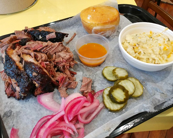 That brisket arrives looking like it graduated summa cum laude from Smoke University.