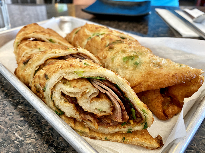 Behold the star attraction: golden-brown beef pancake wraps that combine flaky, scallion-studded dough with savory filling. Worth crossing county lines for!