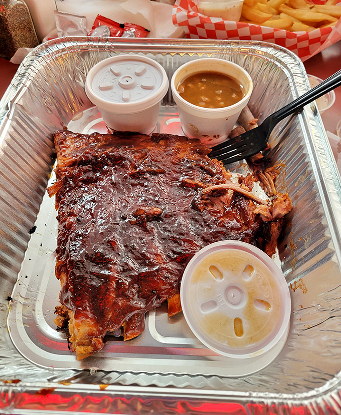 Behold the beef rib that launched a thousand road trips. Glistening with sauce, tender enough to make a vegetarian weep, served with sides that know their supporting role.